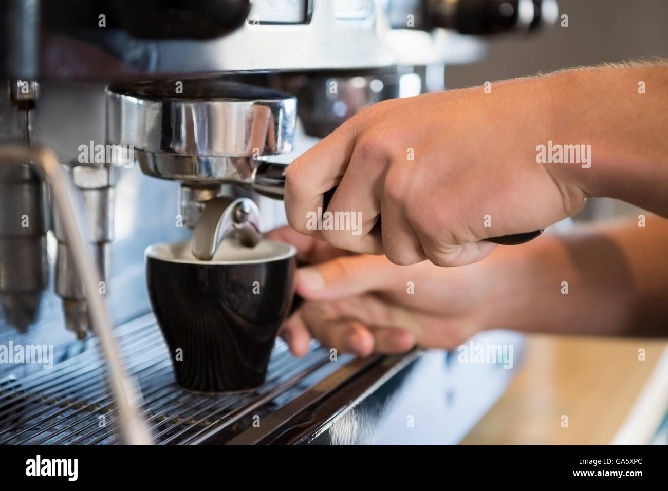 Waiter using coffee machine Stock Photo - Alamy