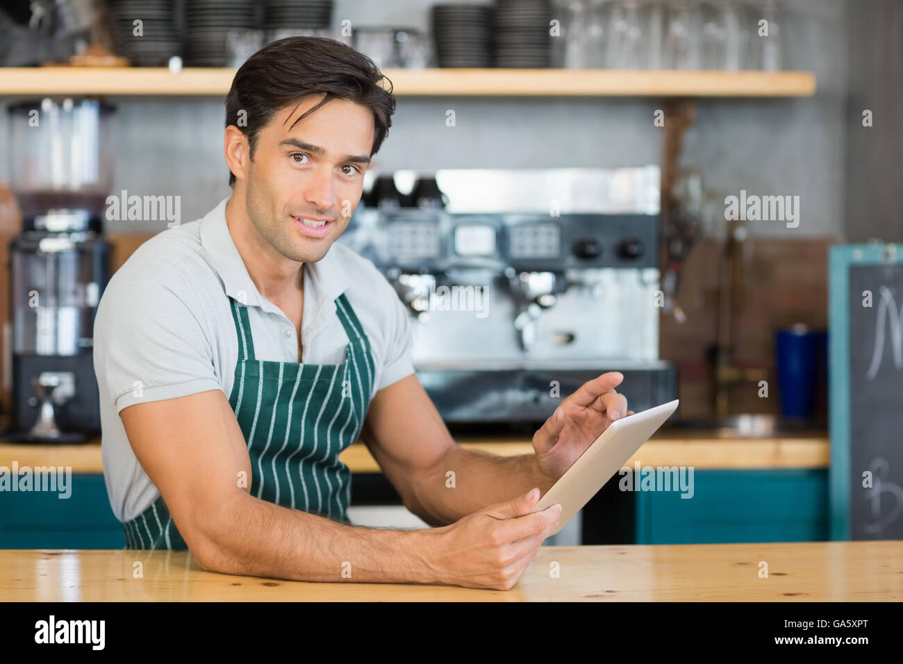 Portrait of waiter using digital tablet Stock Photo - Alamy