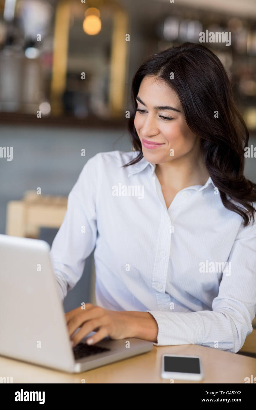 Smiling businesswoman using laptop Stock Photo - Alamy Smiling businesswoman using laptop Stock Photo - Alamy