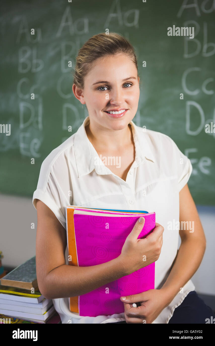 Portrait of smiling school teacher in classroom Stock Photo - Alamy