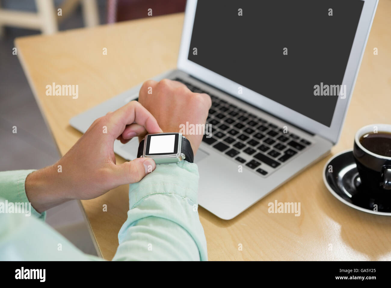 Man adjusting time on his smartwatch Stock Photo - Alamy
