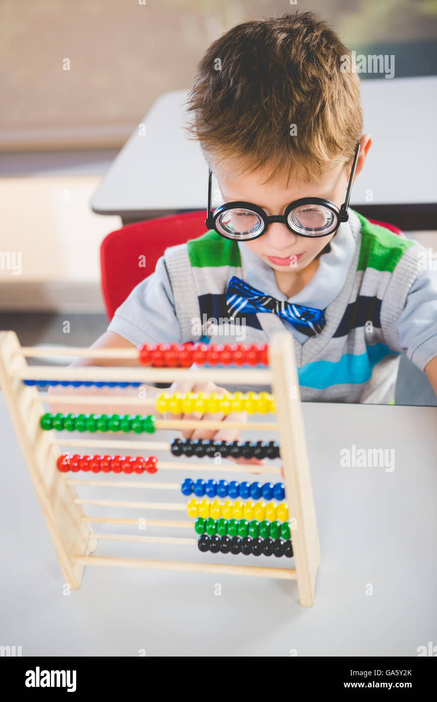 Close-up of schoolkid counting abacus in classroom Stock Photo - Alamy