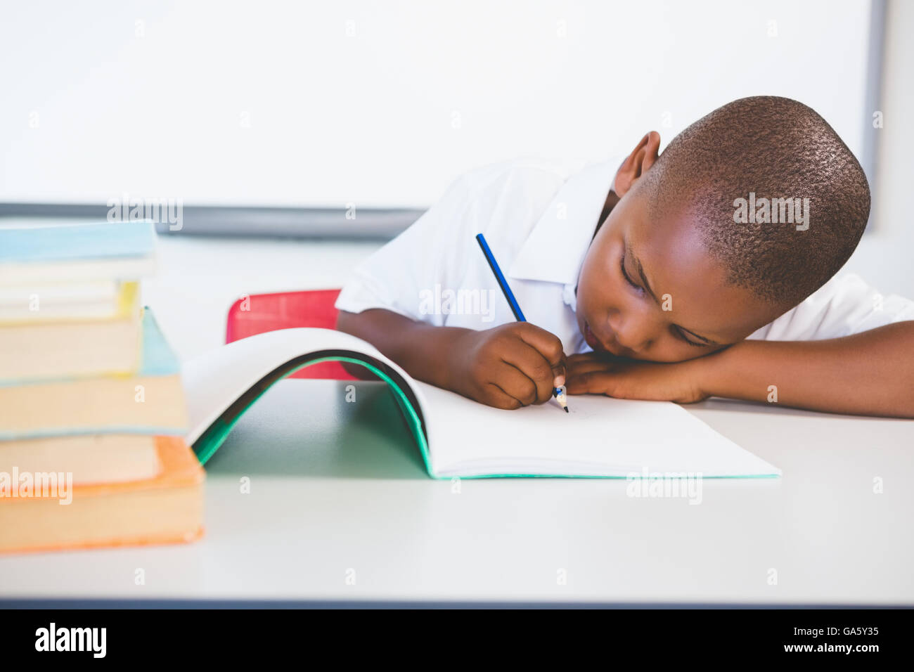 Focused boy doing homework desk hi-res stock photography and images - Alamy