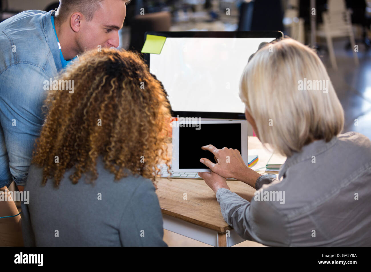 Business people discussing over digital tablet Stock Photo - Alamy