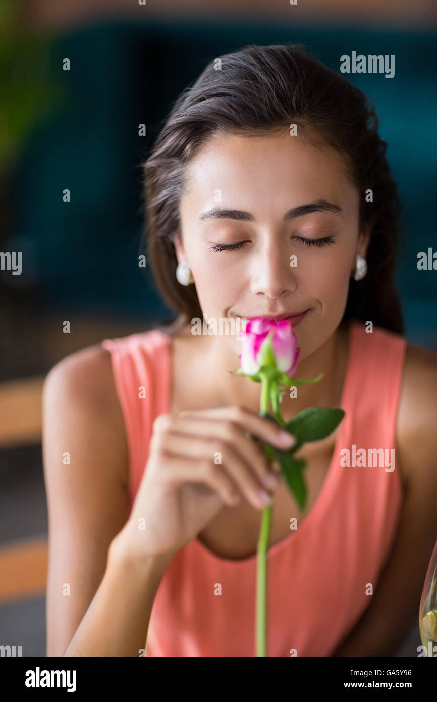 Portrait of smiling woman smelling a rose Stock Photo - Alamy