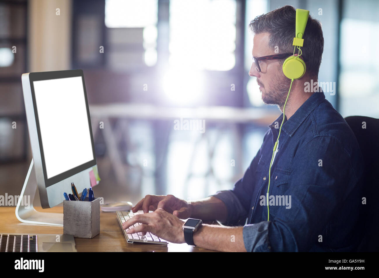 Man using computer in office Stock Photo - Alamy