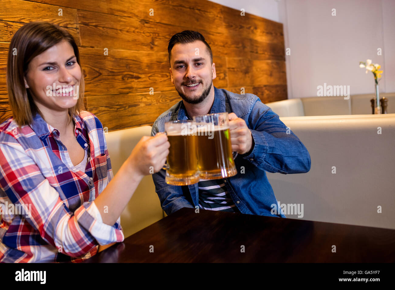 Cheerful couple toasting beer Stock Photo - Alamy