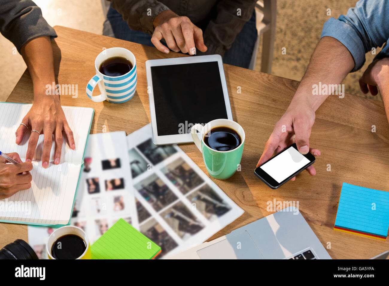 Creative business people working at table in office Stock Photo - Alamy