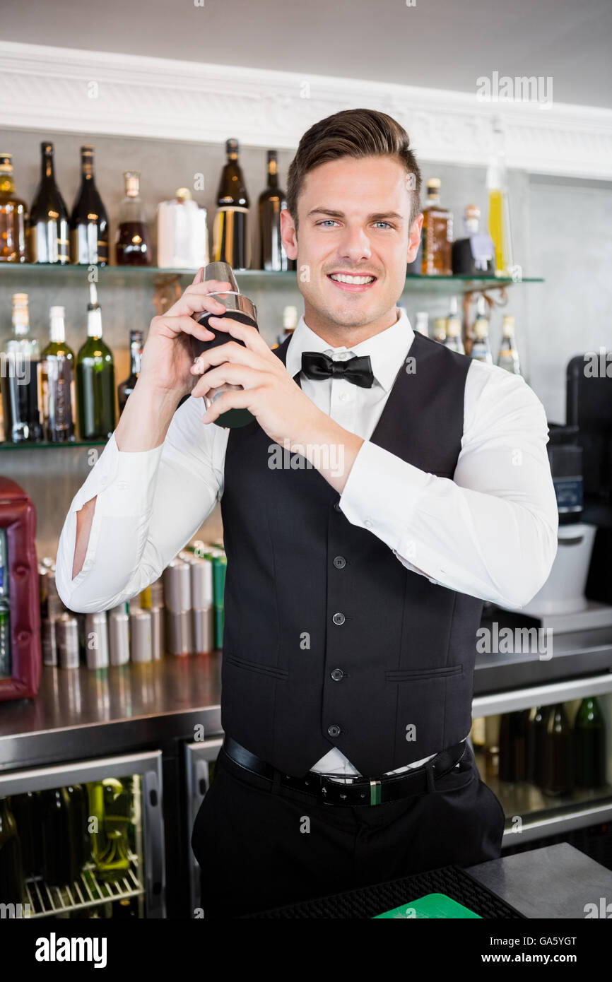 Waiter shaking cocktail Stock Photo - Alamy