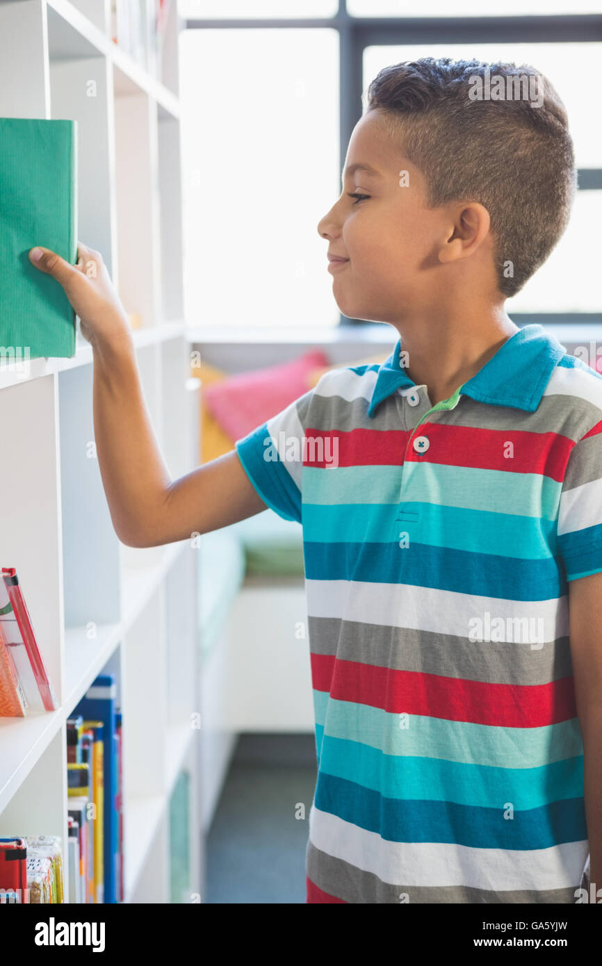 Boy choosing book from library hi-res stock photography and images - Alamy