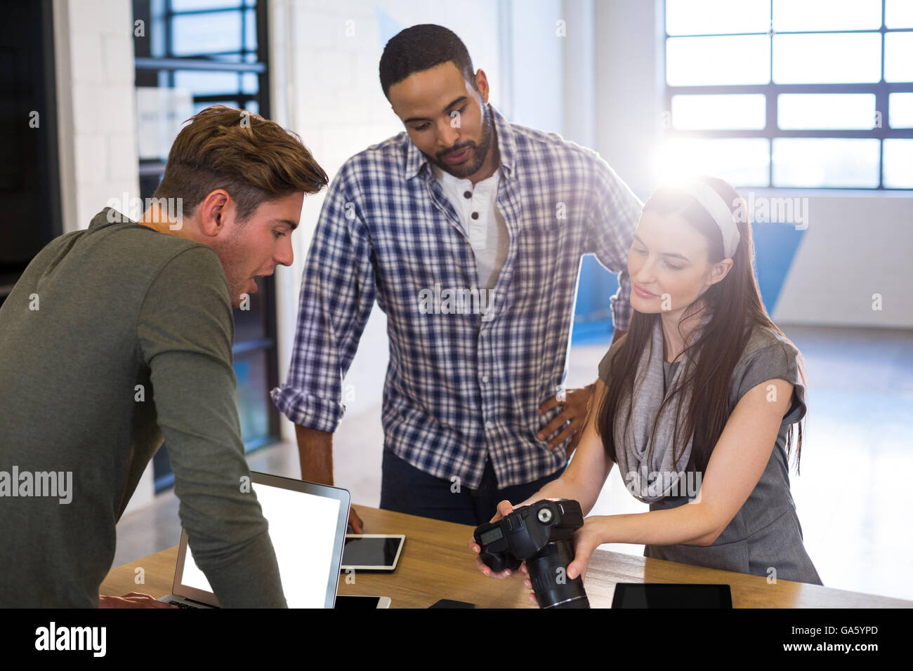 Business people using camera in office Stock Photo - Alamy