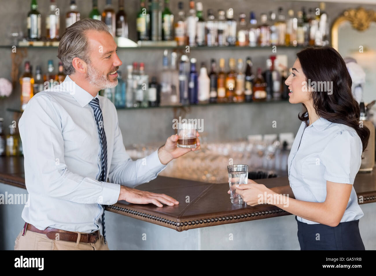 Businessman standing bar holding glass hi-res stock photography and ...