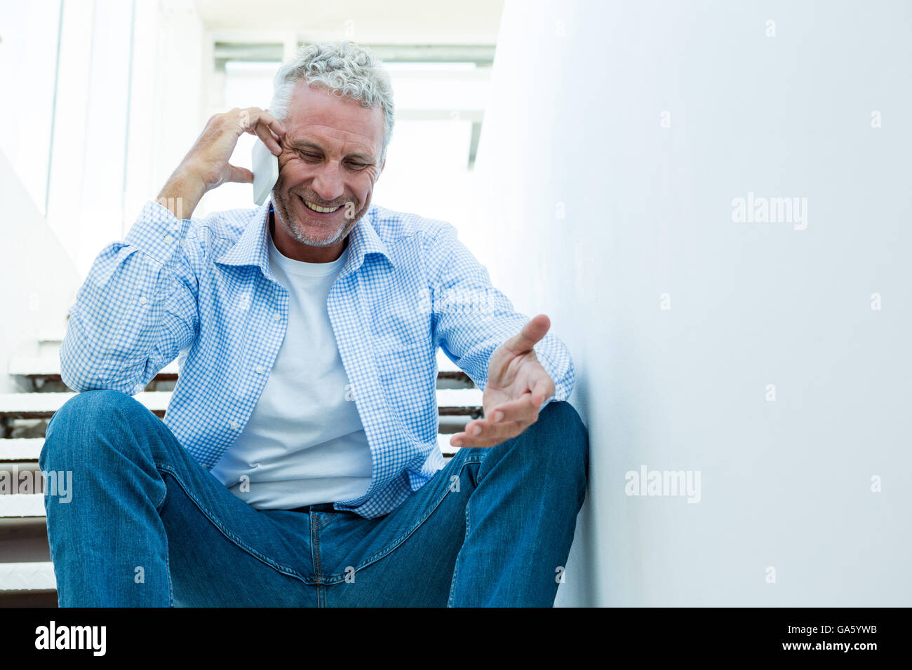 Happy man talking on phone Stock Photo - Alamy
