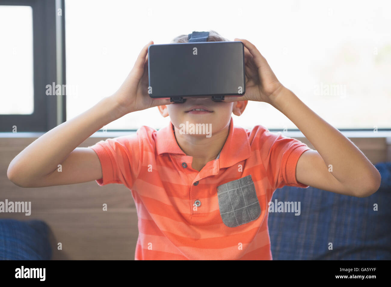 School kid using virtual reality glasses in library Stock Photo - Alamy