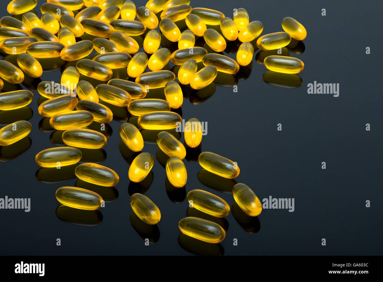 Fish Oil Capsules, Yellow Vitamins, on Black Background Stock Photo - Alamy