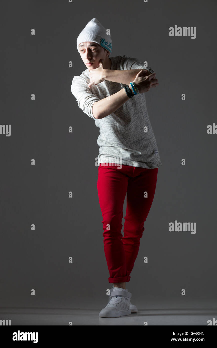 Portrait of one attractive teen dancer guy dancing, working out wearing ...