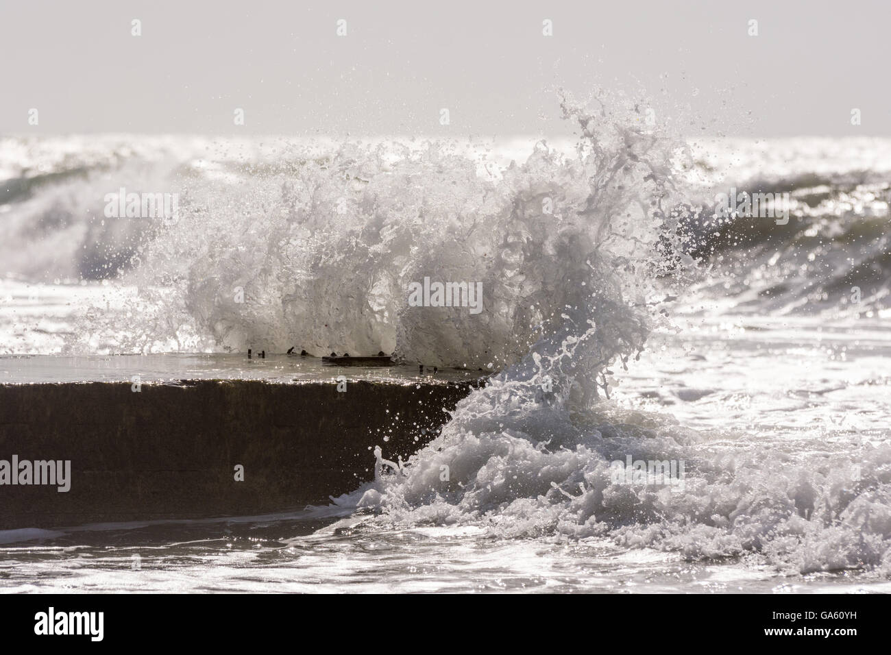 Waves breaking on the concrete pier Stock Photo - Alamy