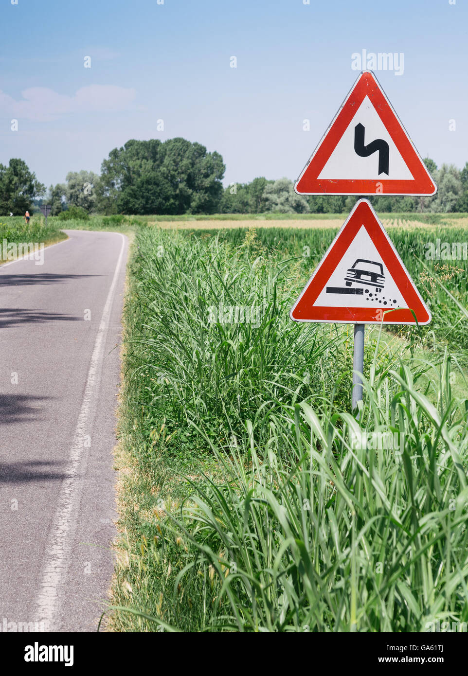 Hazardous Shoulder European road sign along dirt road in Italian ...