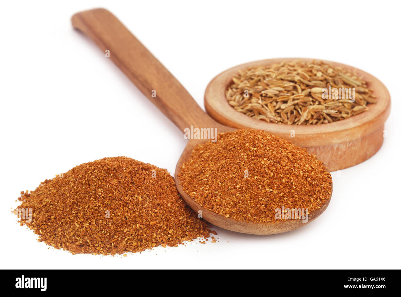 Crushed cumin with whole ones over white background Stock Photo - Alamy