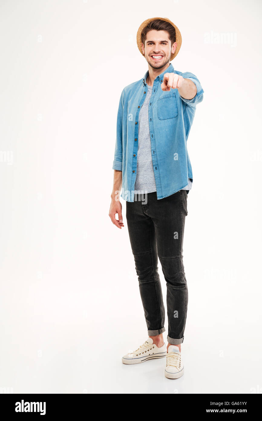 Full length portrait of a young casual man pointing finger at camera ...