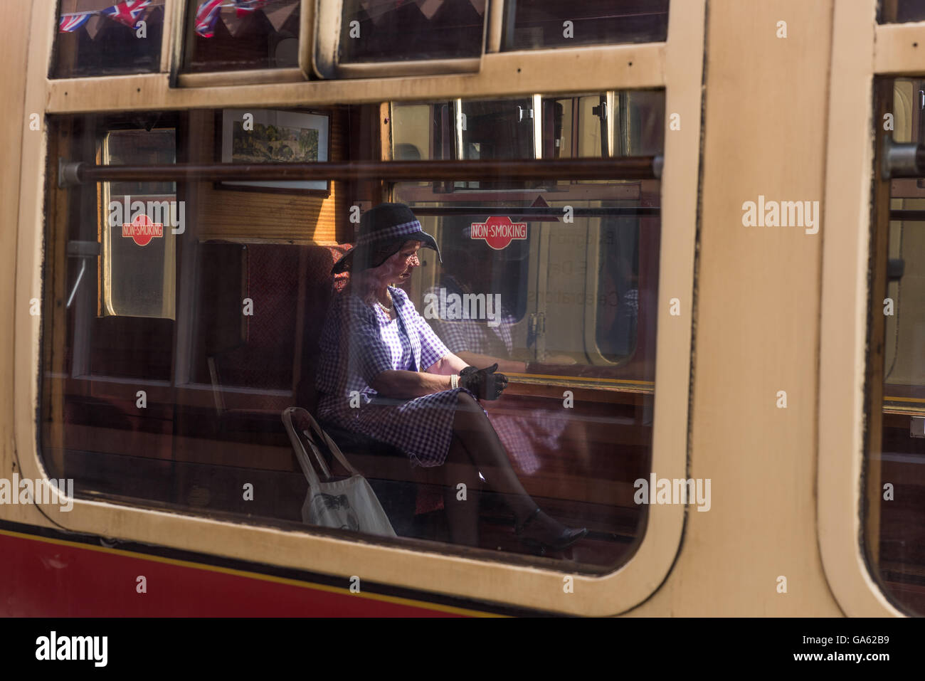An elegant mature lady through the window of a steam train Stock Photo ...