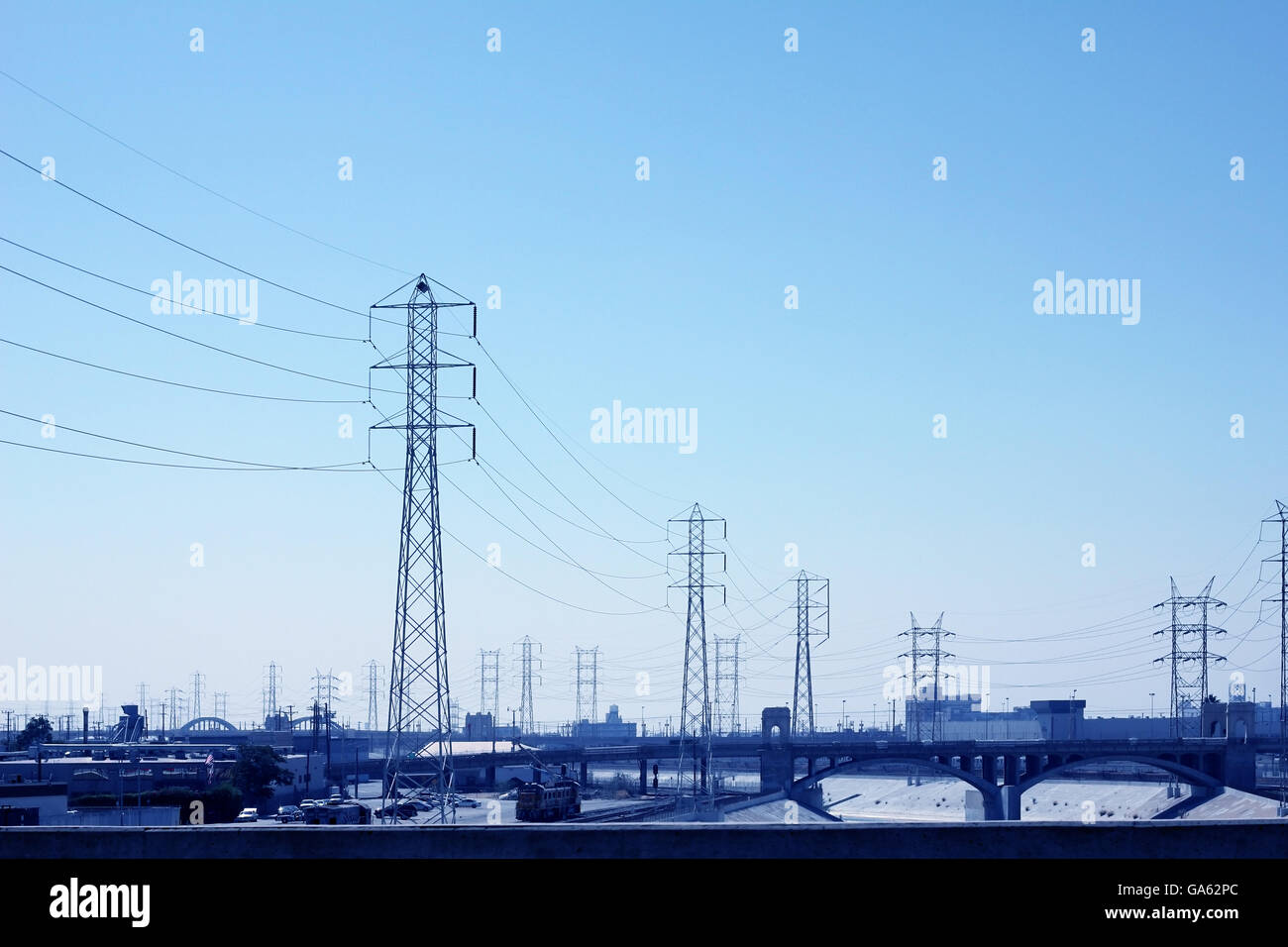 A long line of electrical transmission towers carrying high voltage ...