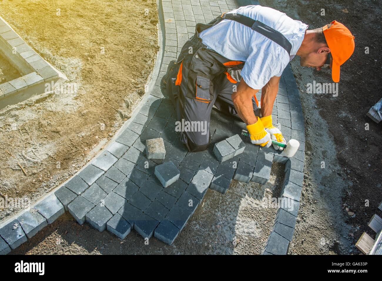 Brick Paving Works. Professional Caucasian Worker Building Block Paved ...