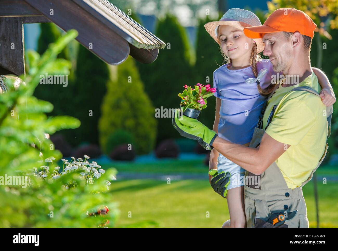 Father and Daughter in Garden. Father Explaining His Child How The ...