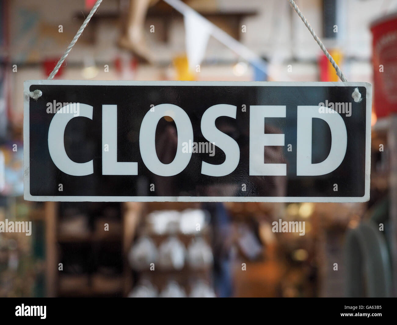 Closed sign in a shop showroom with reflections Stock Photo - Alamy