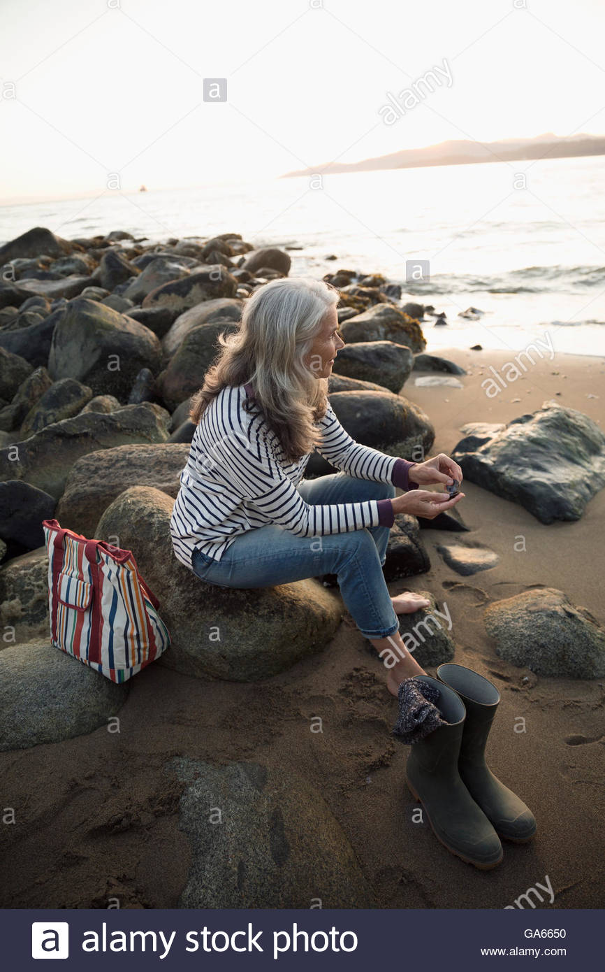 Woman rocks beach hi-res stock photography and images - Alamy