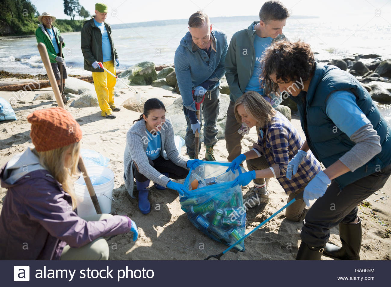 People Picking Up Litter On The Beach