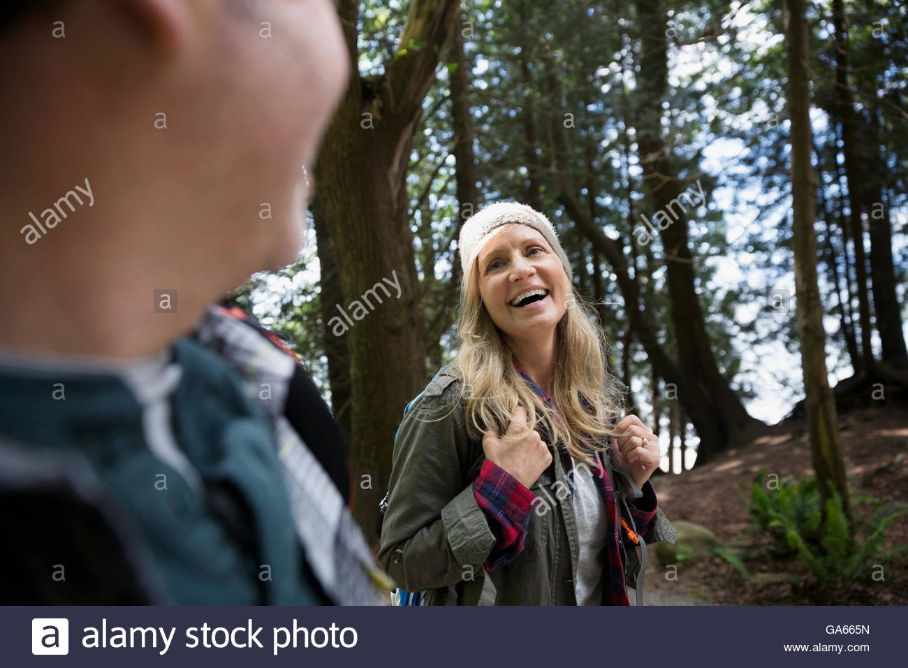 Laughing couple hiking in woods Stock Photo - Alamy