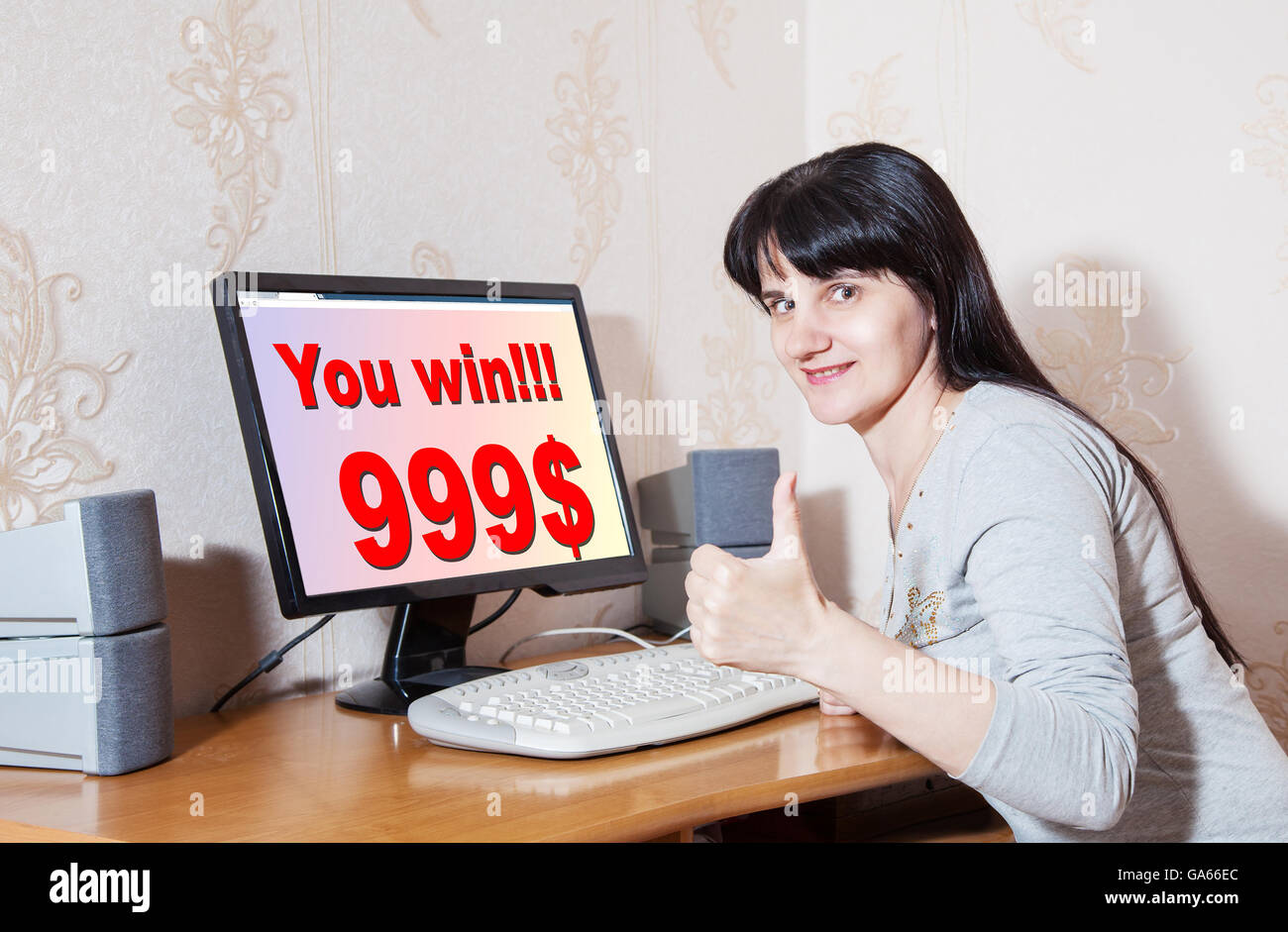 young brunette woman rejoices win $ 999 Stock Photo - Alamy