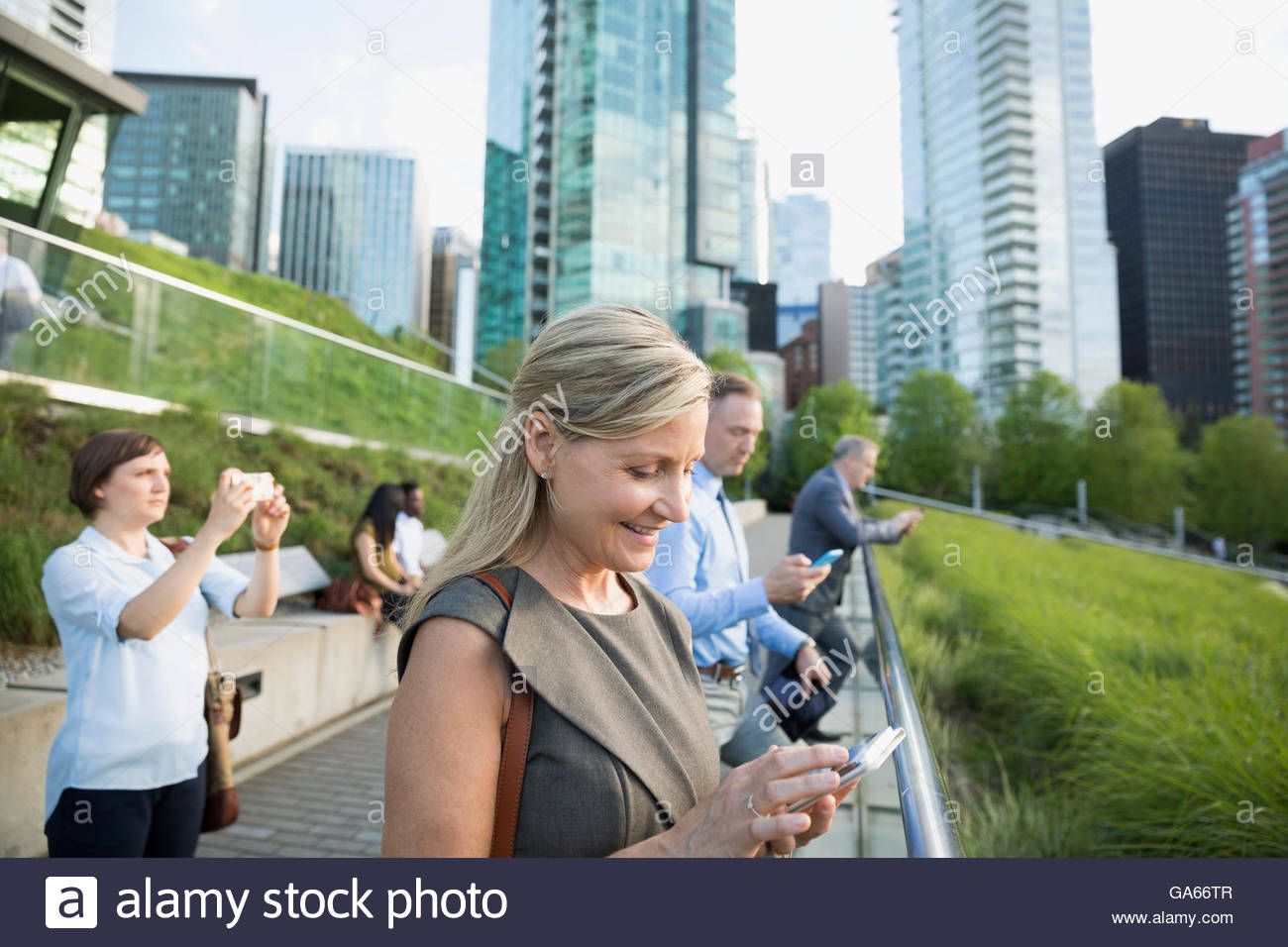 Business people using cell phones in city Stock Photo - Alamy