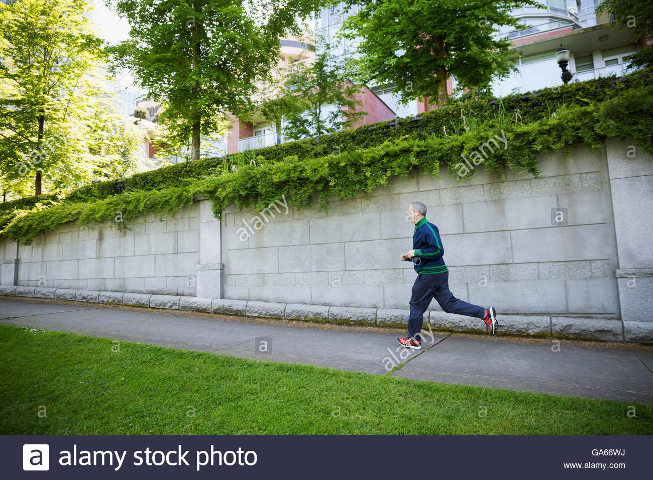 Man running on suburban sidewalk Stock Photo - Alamy