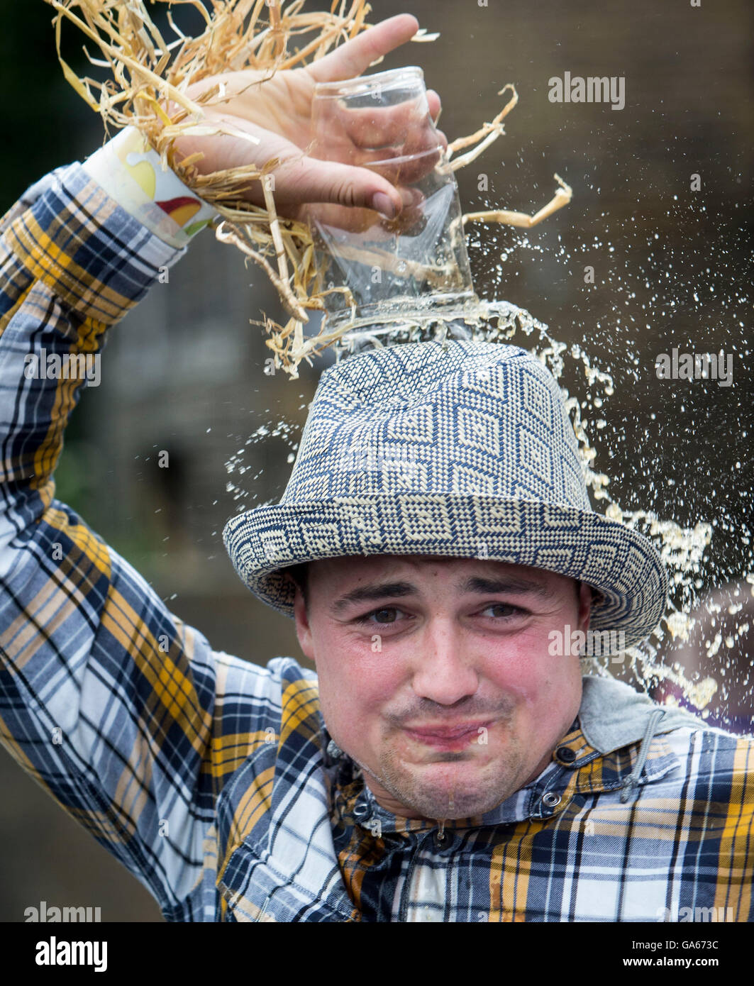 A competitor takes part on the Oxenhope Straw Race in Yorkshire, which ...