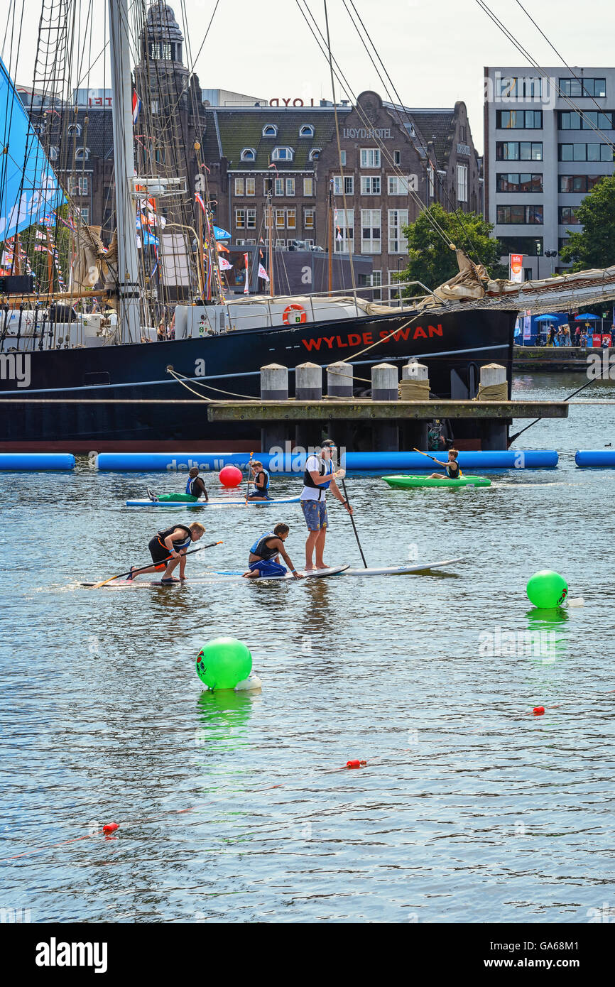 Paddling on a surfboard during Sail Amsterdam 2015 Stock Photo - Alamy