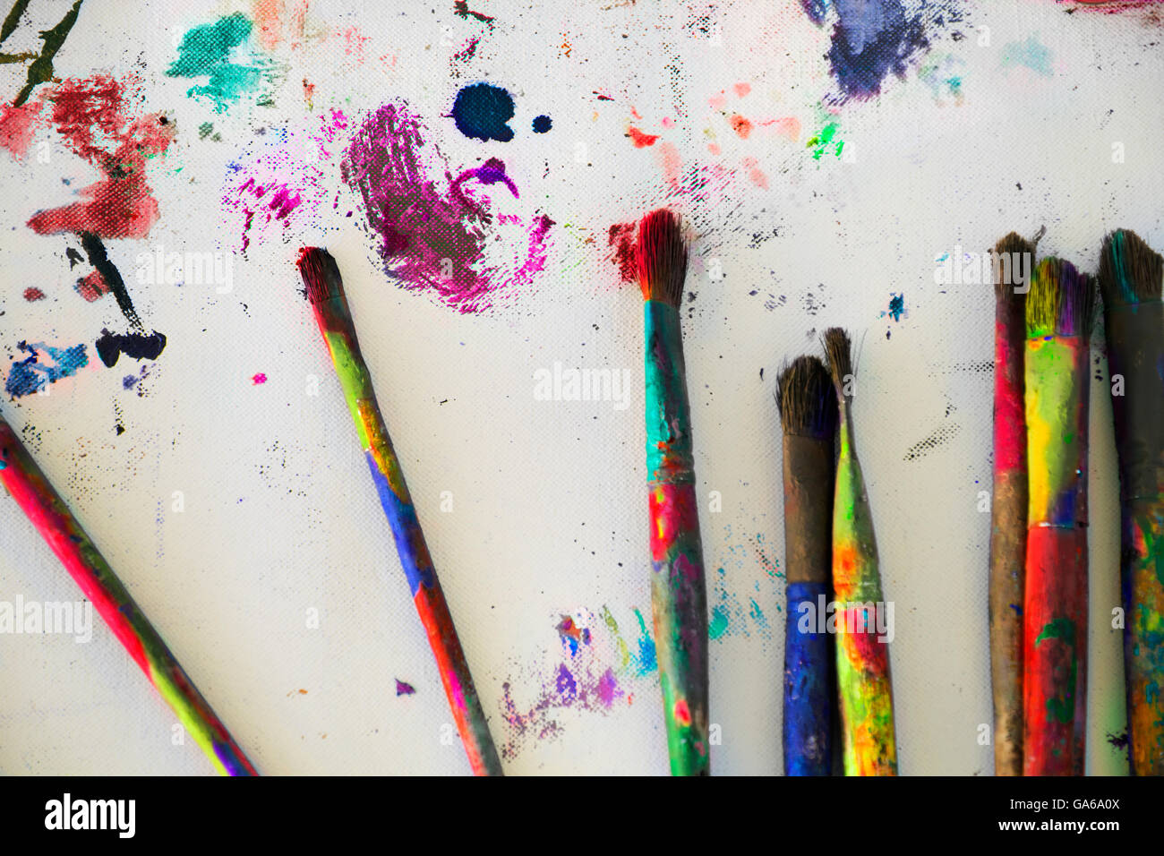 paint brushes, stained canvas background Stock Photo - Alamy