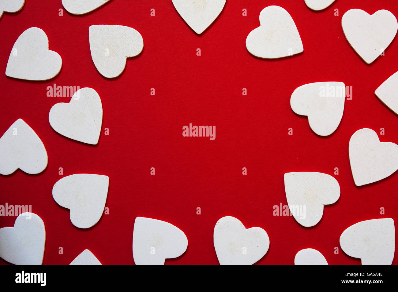 multiple hearts whites shapes, forming a circular frame on red ...