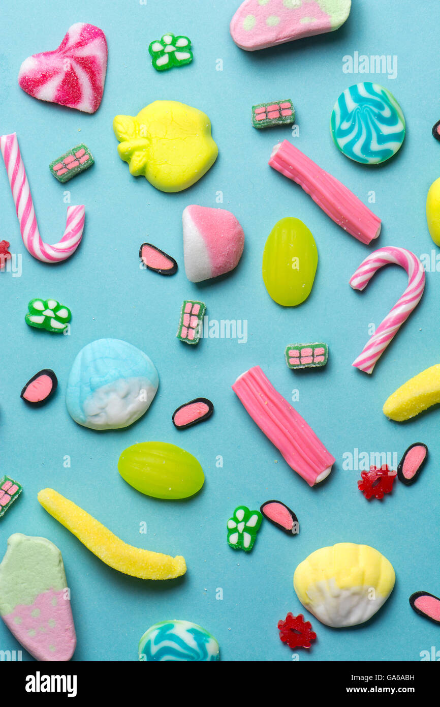 mixed collection of colorful candy, on blue background, kids holidays ...