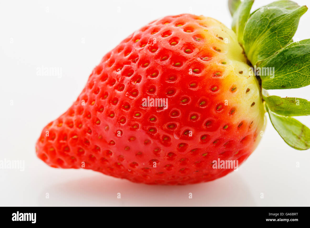 Closeup of not fully ripe strawberry Stock Photo - Alamy