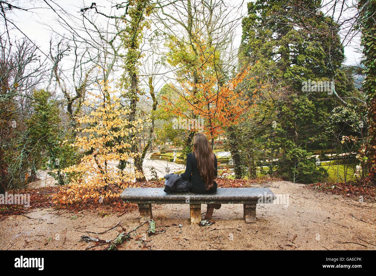 Girl resting in the forest, sitting back Stock Photo - Alamy