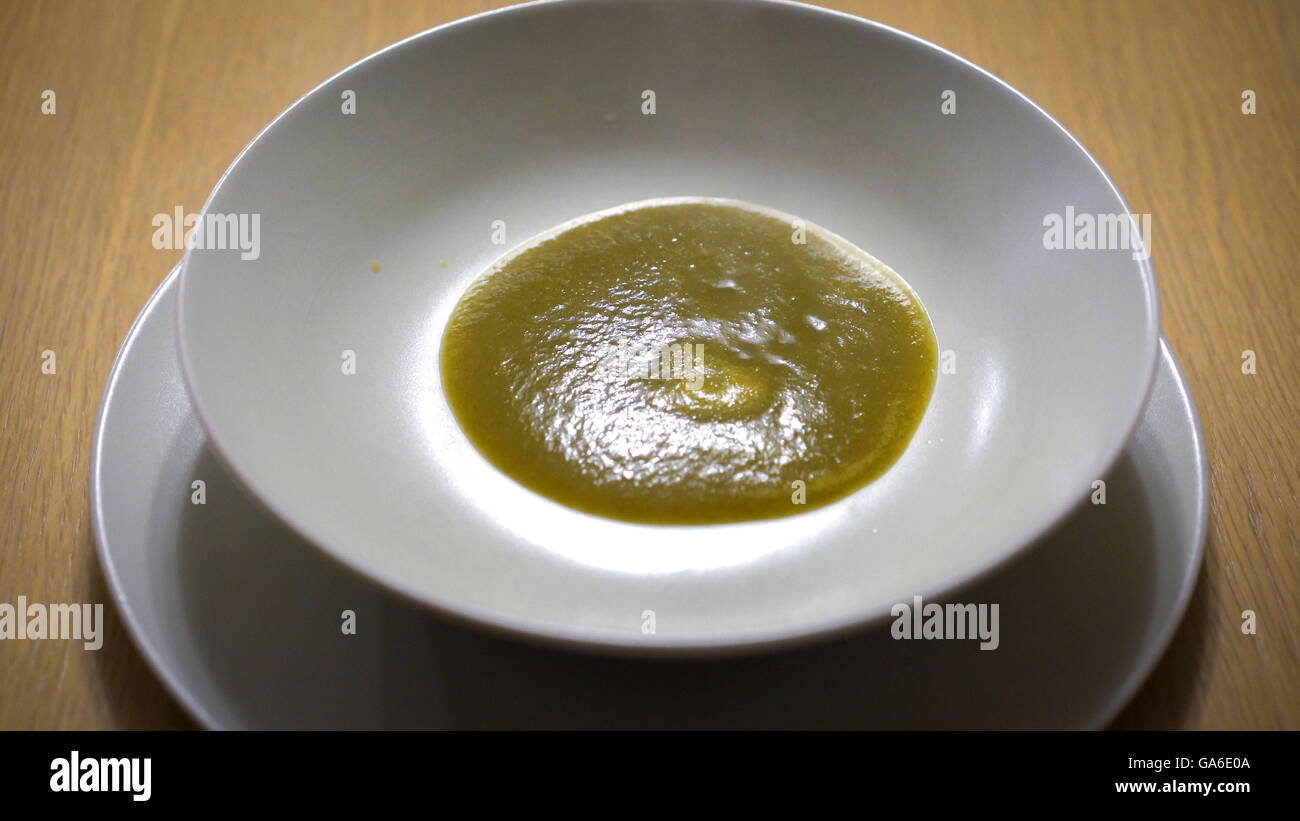 Vegetable soup poured in a white dish Stock Photo - Alamy