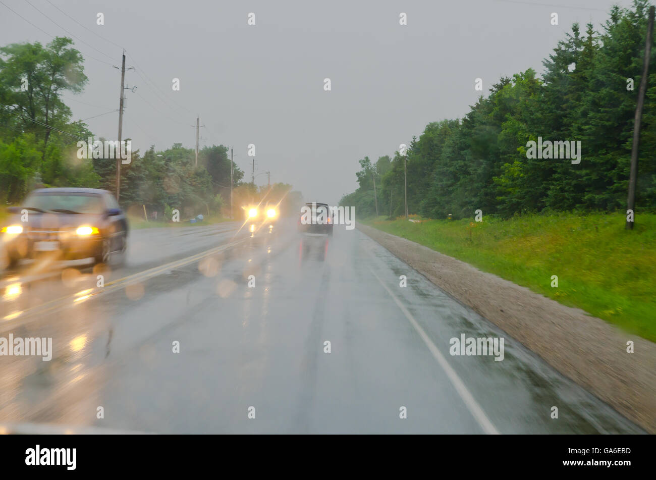 Countryside road and several cars in rainy overcast day. Canada Stock ...