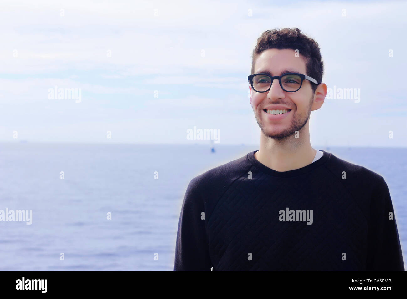 Portrait of young latin man by the ocean. Hispanic man smiling Stock ...