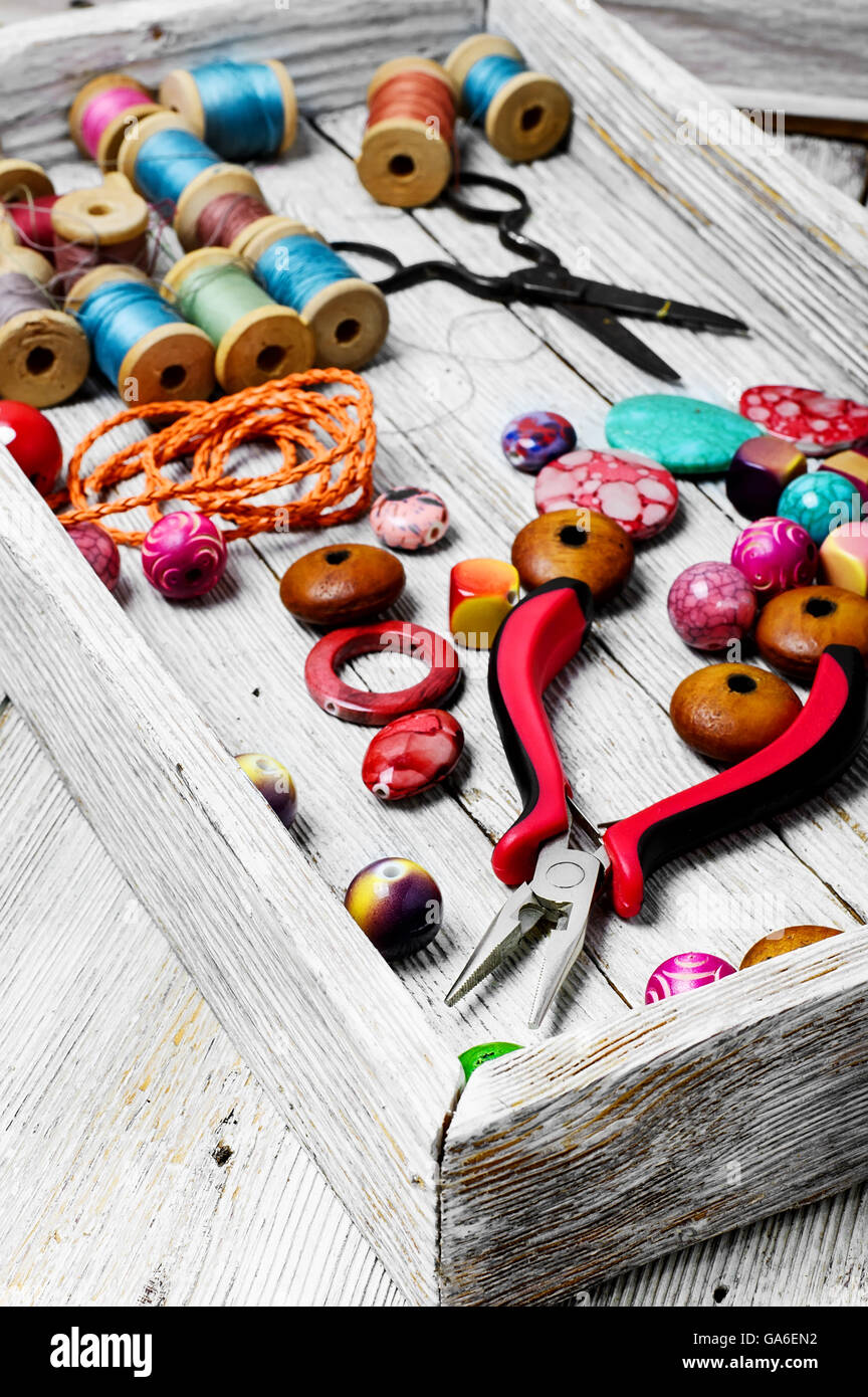Beads and thread working tools for craft and skill Stock Photo - Alamy