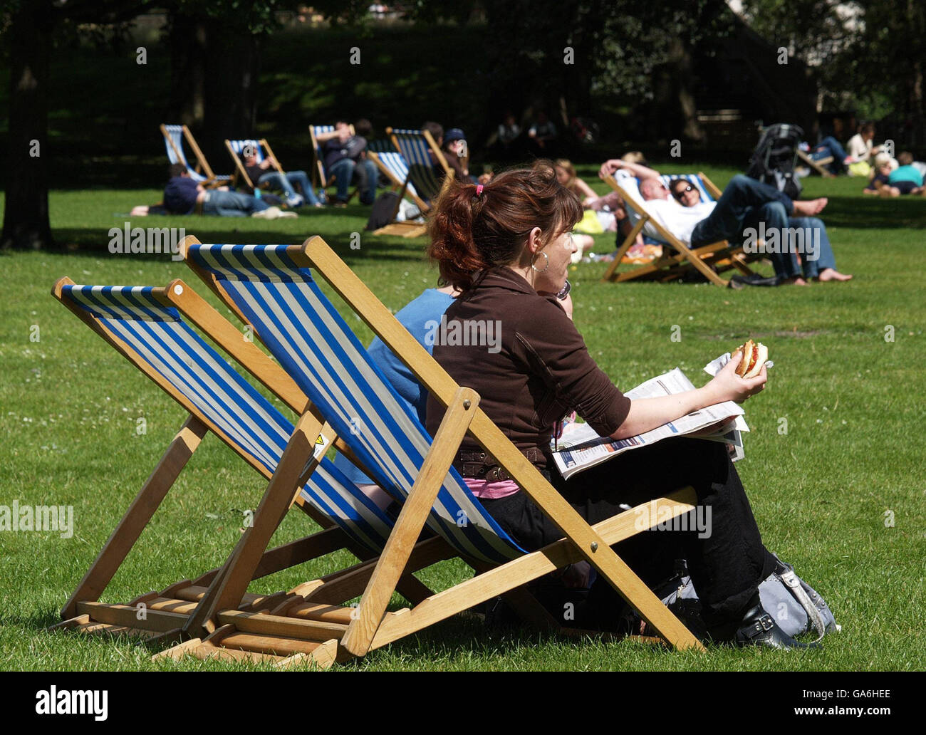 People enjoy the sun in Hyde Park, London, while many areas of the ...