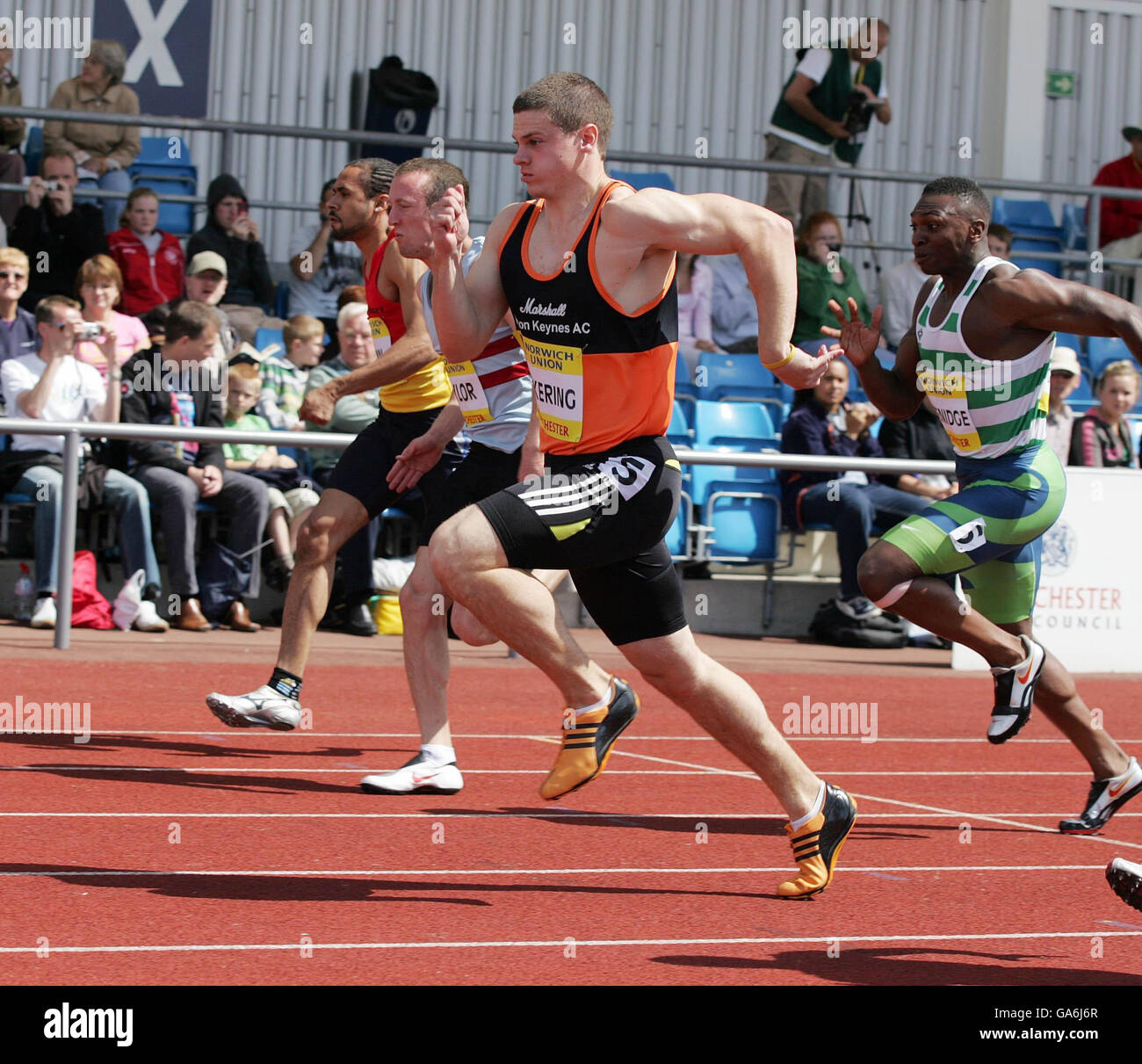 Craig Pickering (orange top) wins his Mens' 100m heats during the ...