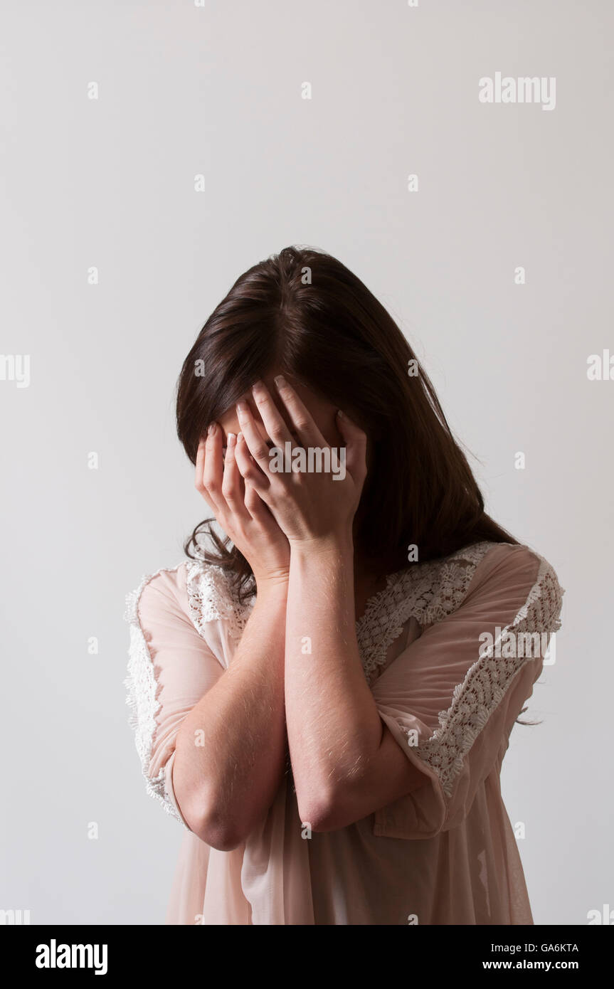 Woman hiding face in hands crying Stock Photo - Alamy