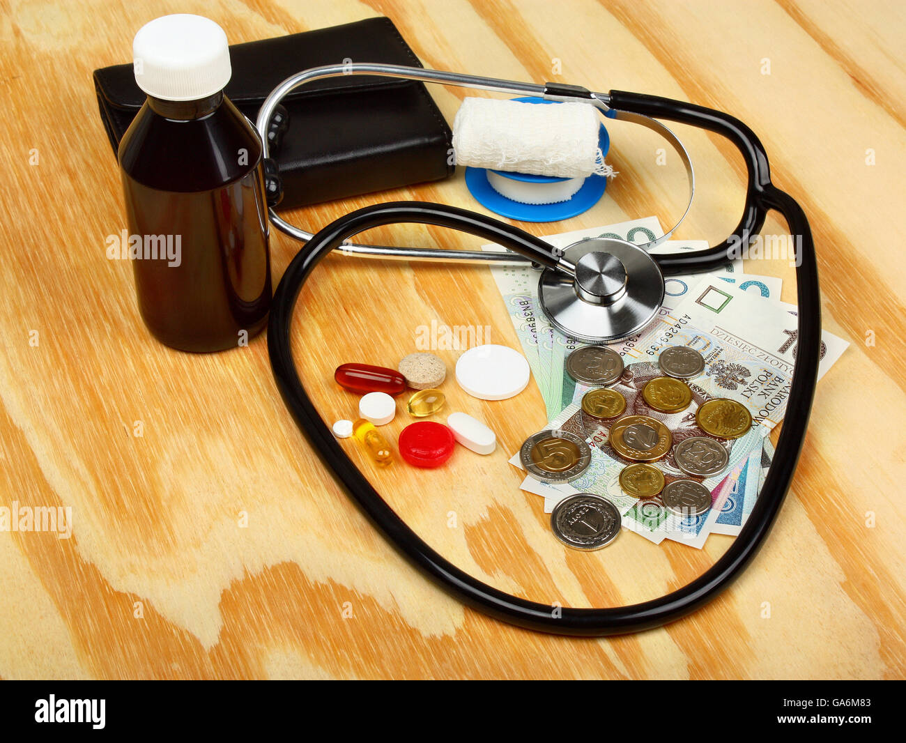 Stethoscope on polish money, bandage, wallet, syrup Stock Photo - Alamy